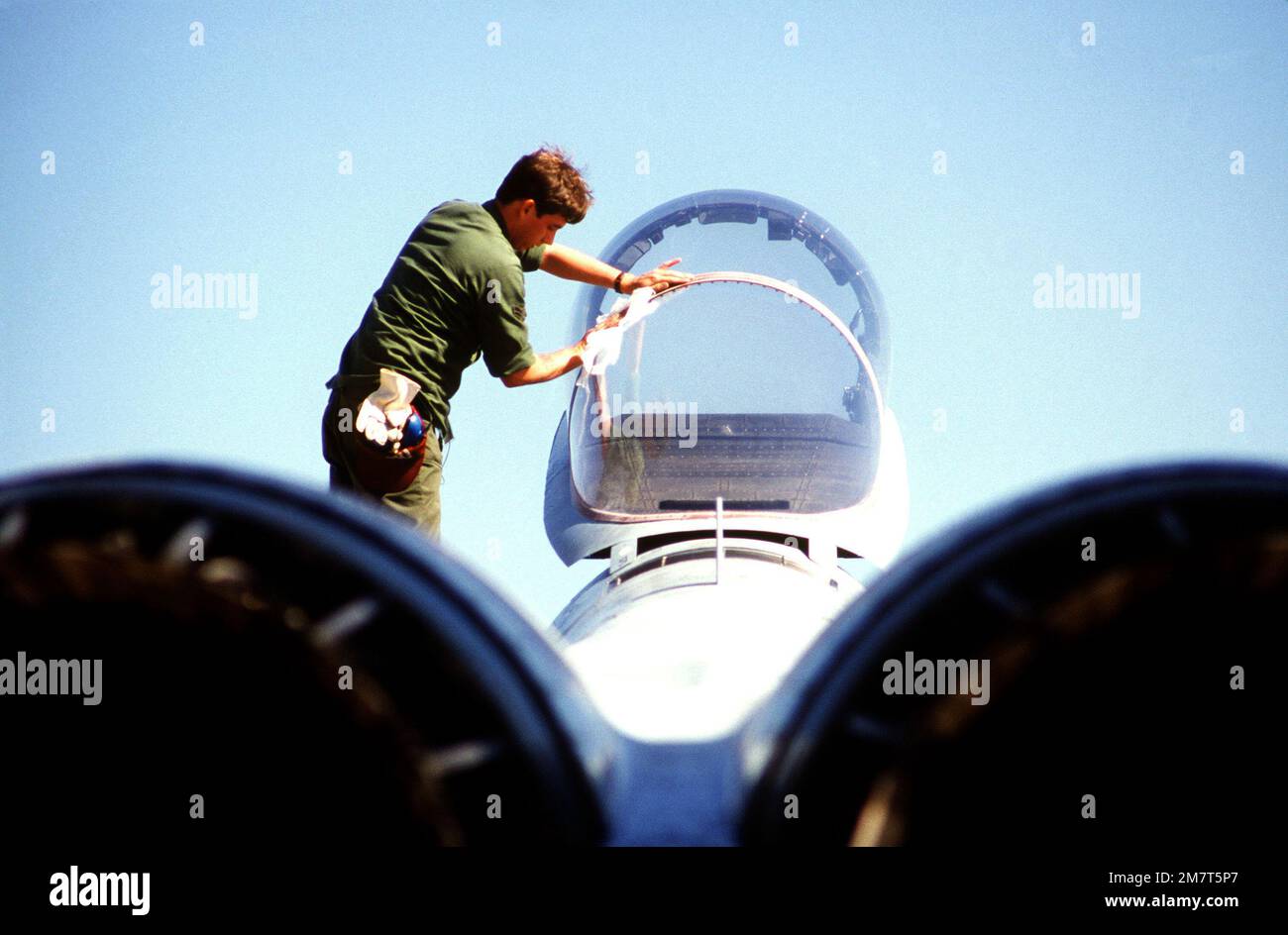 AIRMAN 1ST Class Steven Pierce cleans the canopy of an F-15 Eagle ...