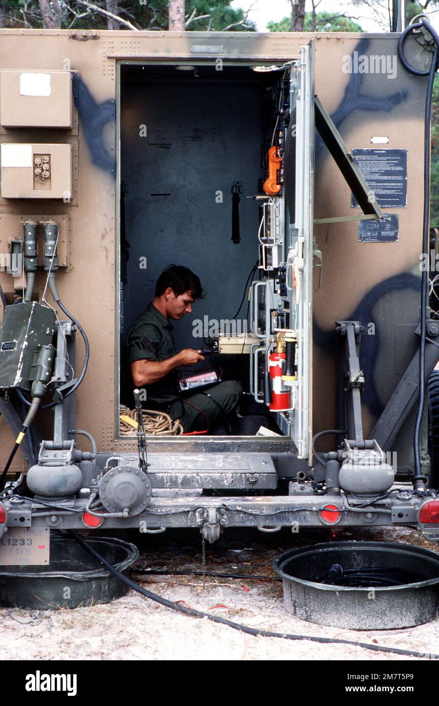 Sergeant Edward Irvine, 728th Tactical Control Squadron, replaces parts ...