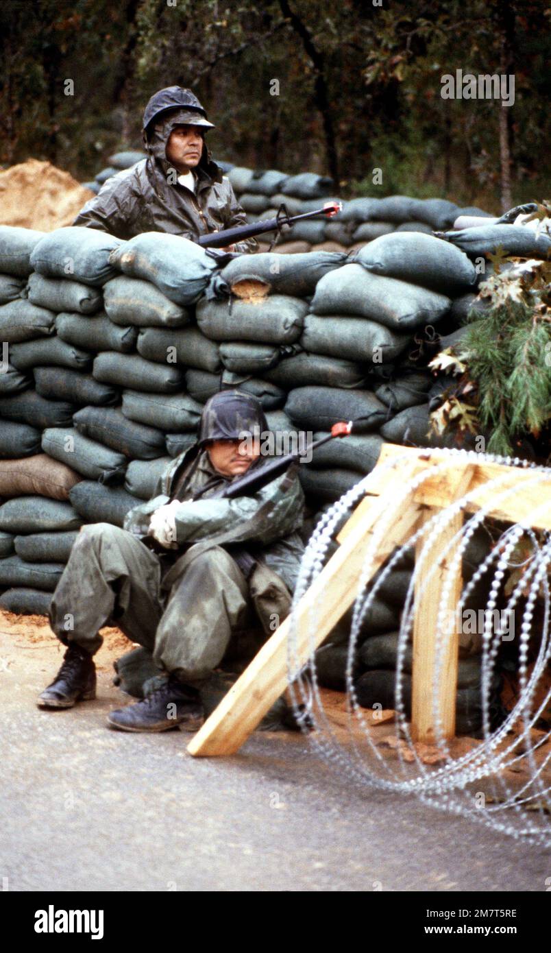 Personnel armed with M16 rifles guard the entry control point to ...