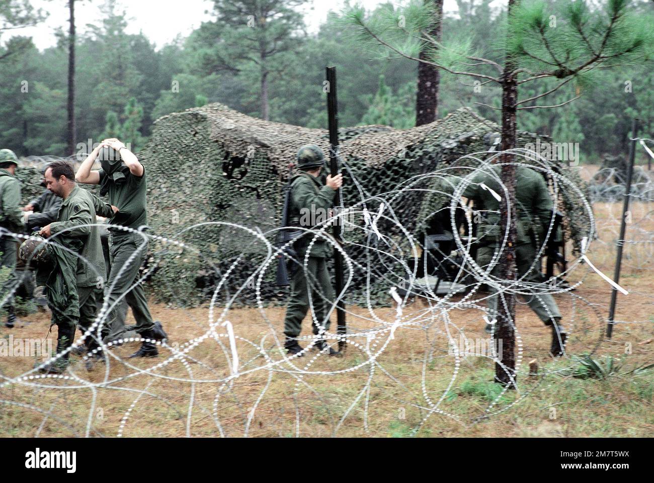 Blindfolded "prisoners of war" are prepared to be transported from a ...