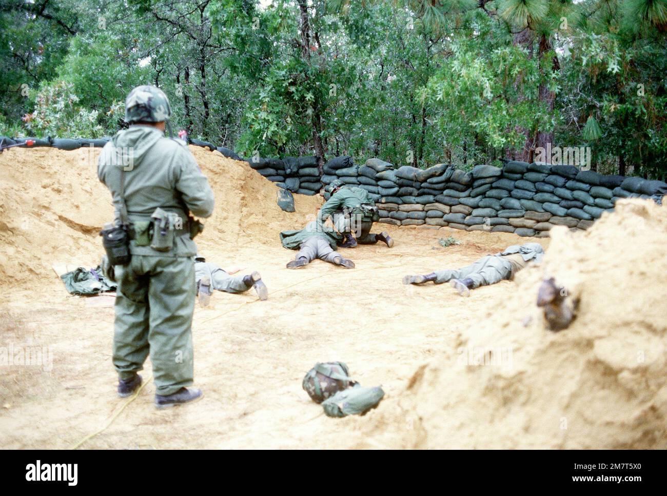 Prisoners of war lying face down and blindfolded, await transportation ...