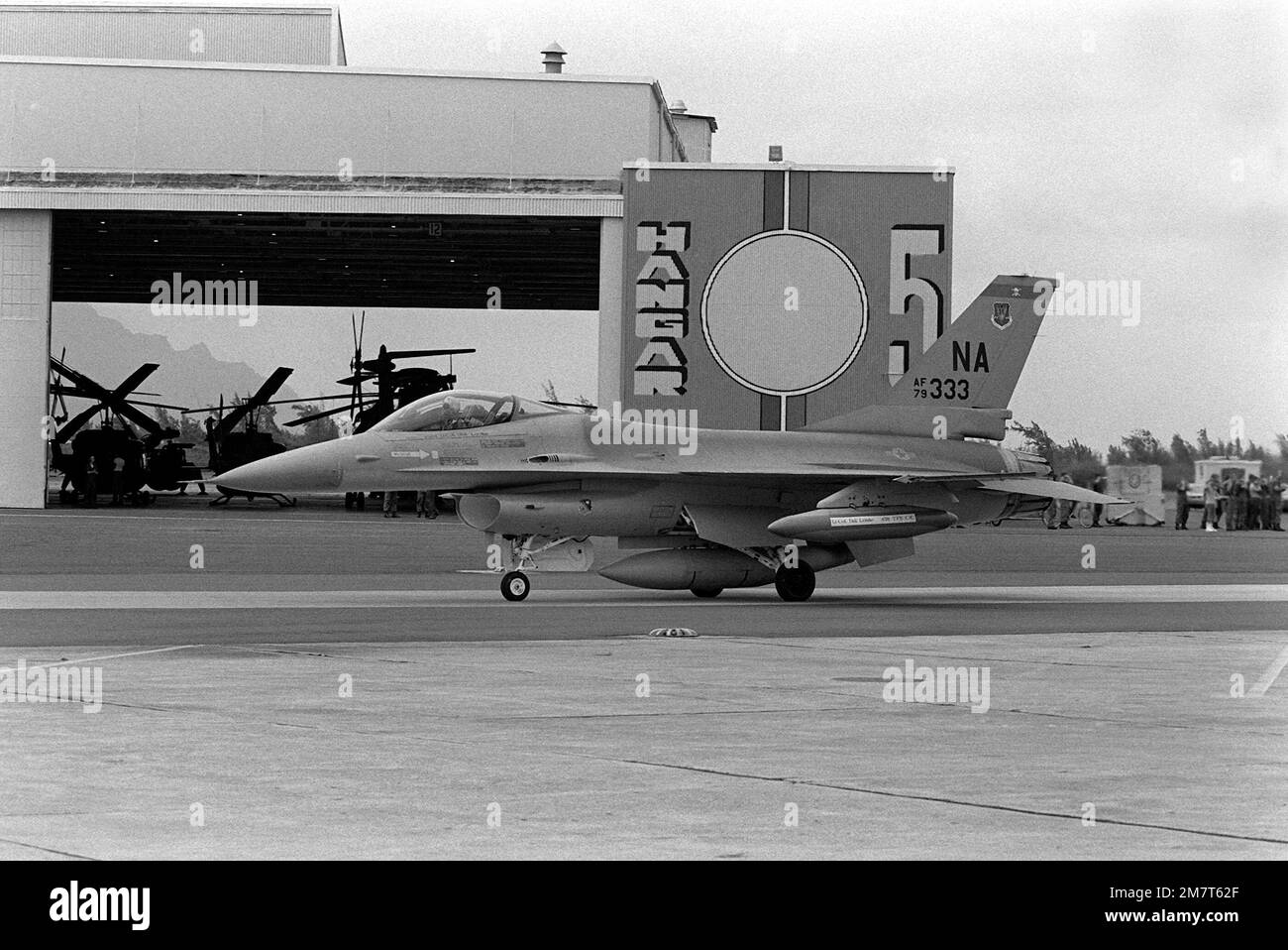 An Air Force F-16A Fighting Falcon aircraft taxis in front of hangar #5 ...