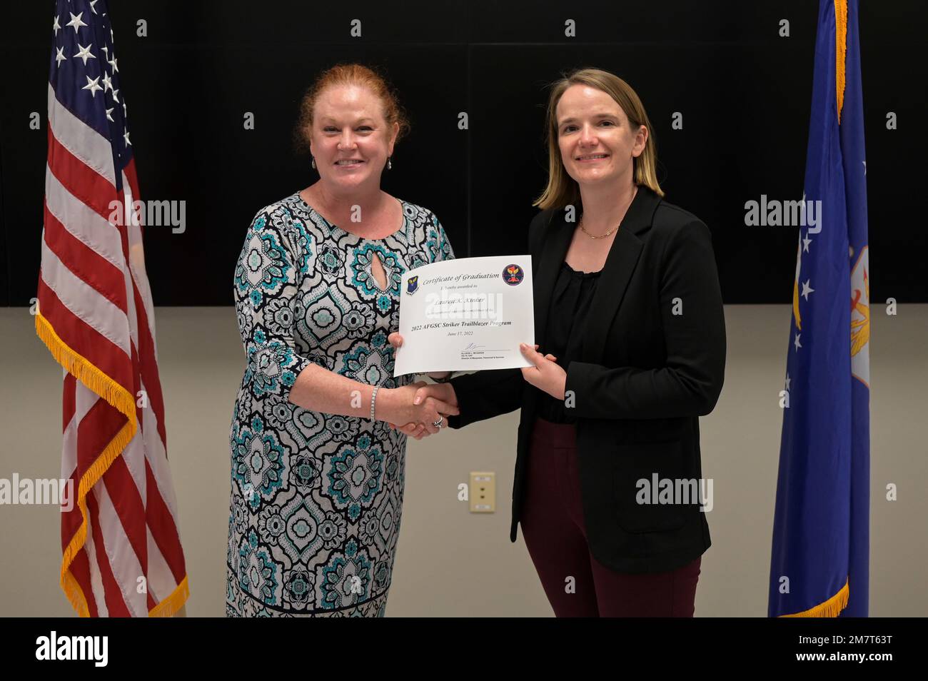 Miss Lauren Kinker, 5th Civil Engineering Squadron graduate, receives a ...