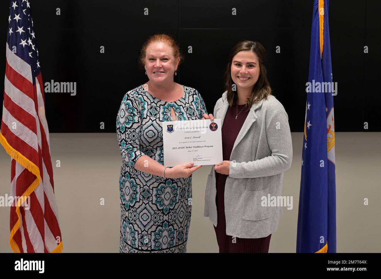 Miss Erin Powell, 2nd Operations Support Squadron graduate, receives a ...