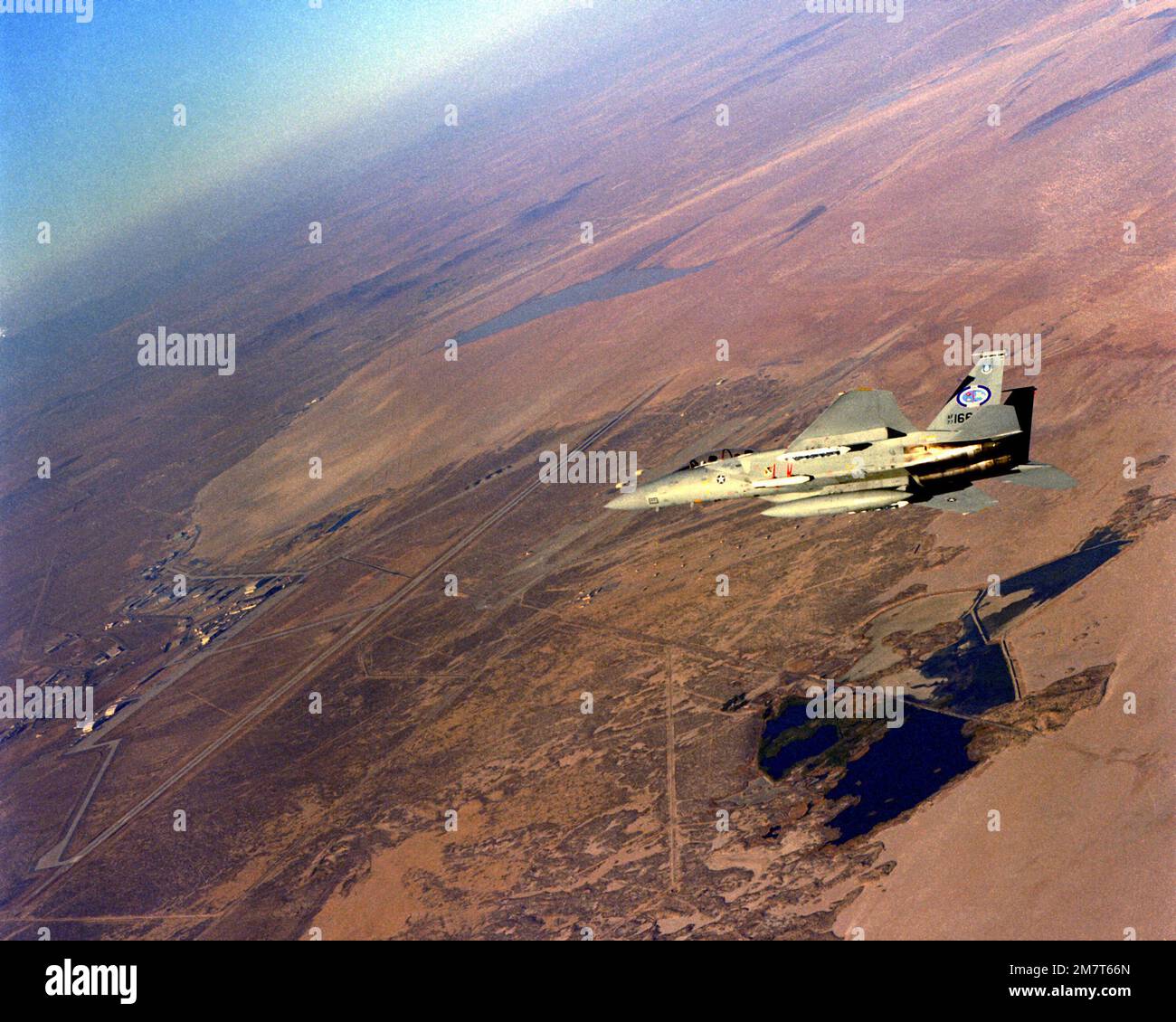 An air-to-air left side view of an F-15 Eagle aircraft equipped with an ...