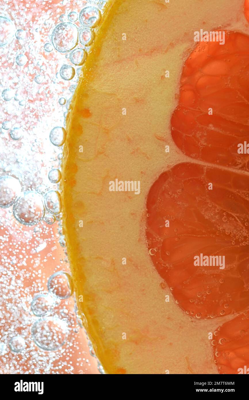 Close-up of fresh grapefruit slice on white background. Slice of red ...