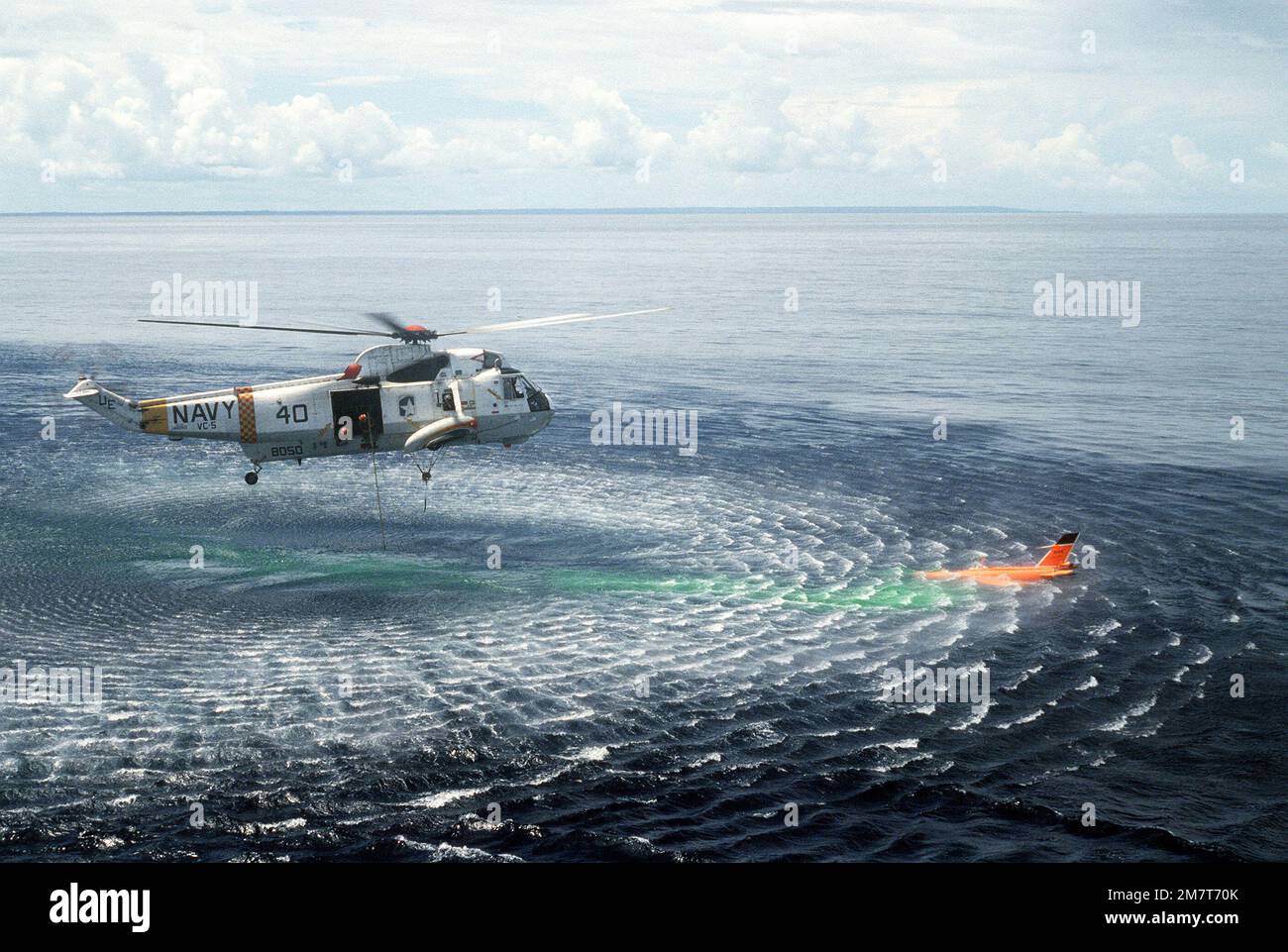 An air-to-air view of an SH-3 Sea King helicopter preparing to attach a ...