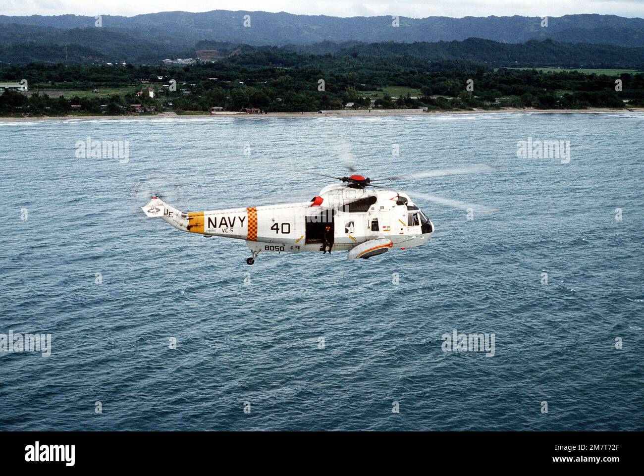 A air-to-air right side view of an SH-3 Sea King helicopter as it ...