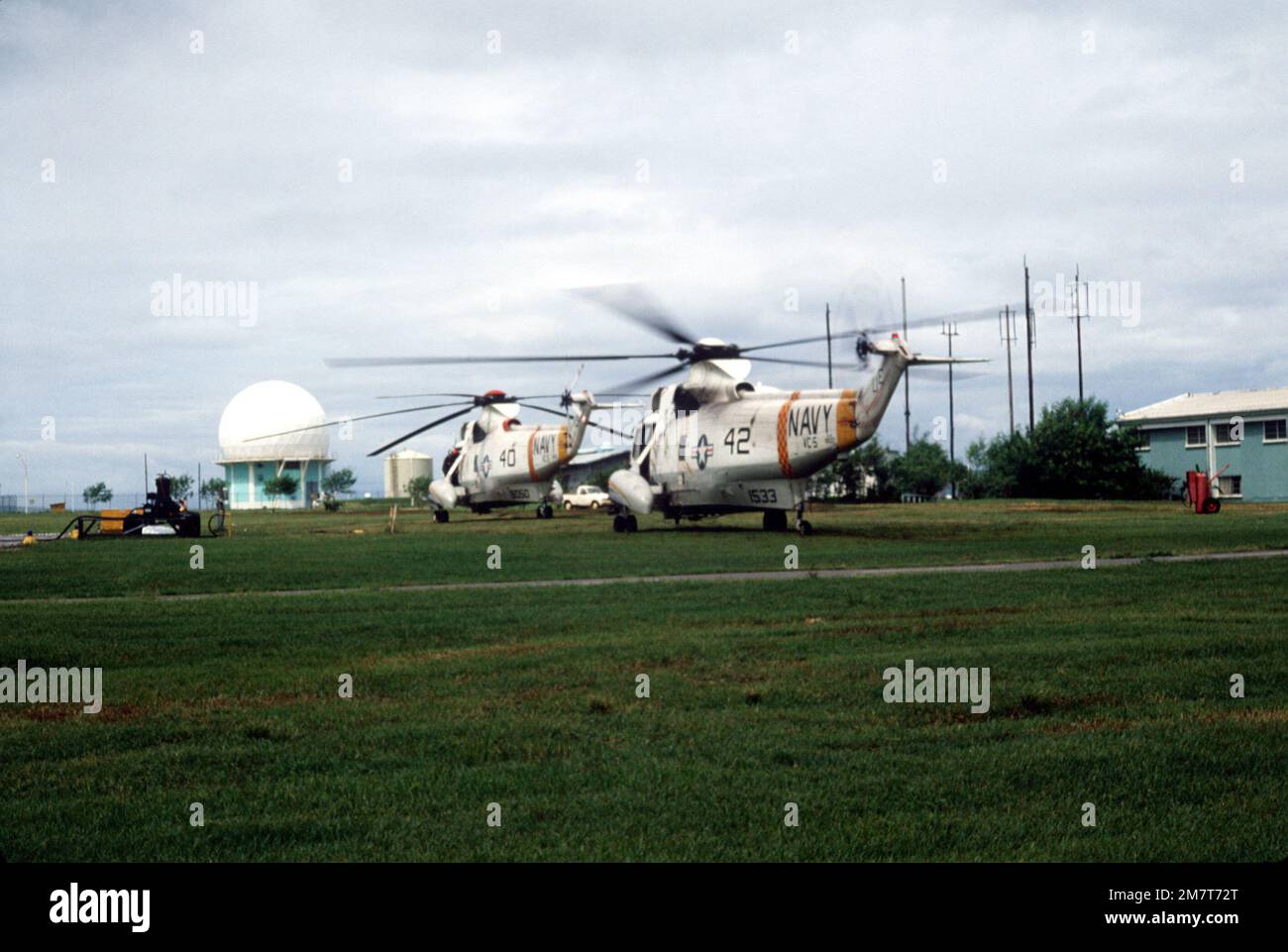A left rear view of two SH-3 Sea King helicopters preparing to take off ...