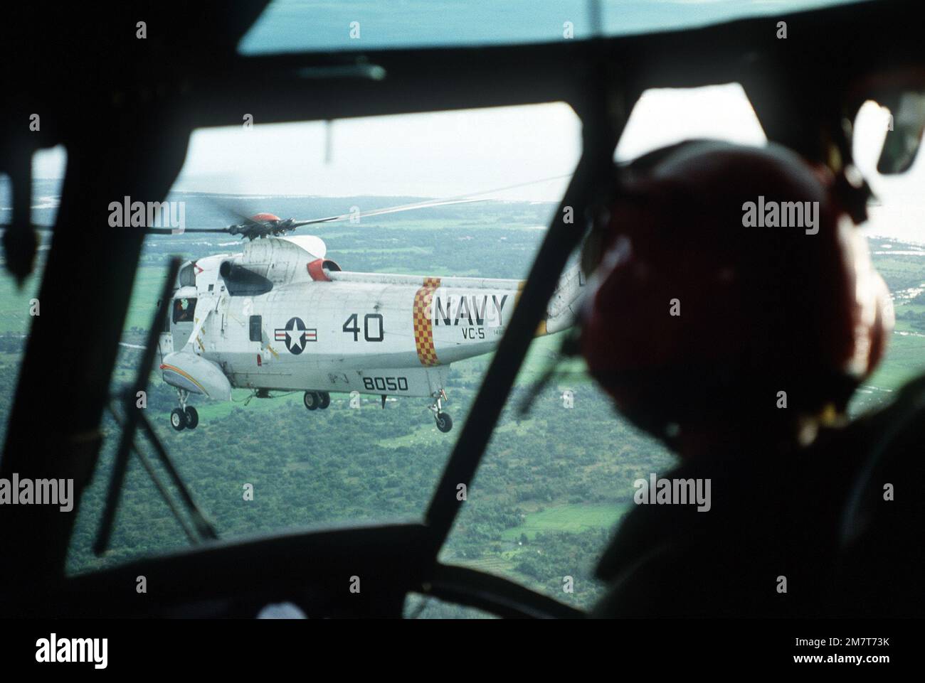 An air-to-air view of an SH-3 Sea King helicopter taken from the ...