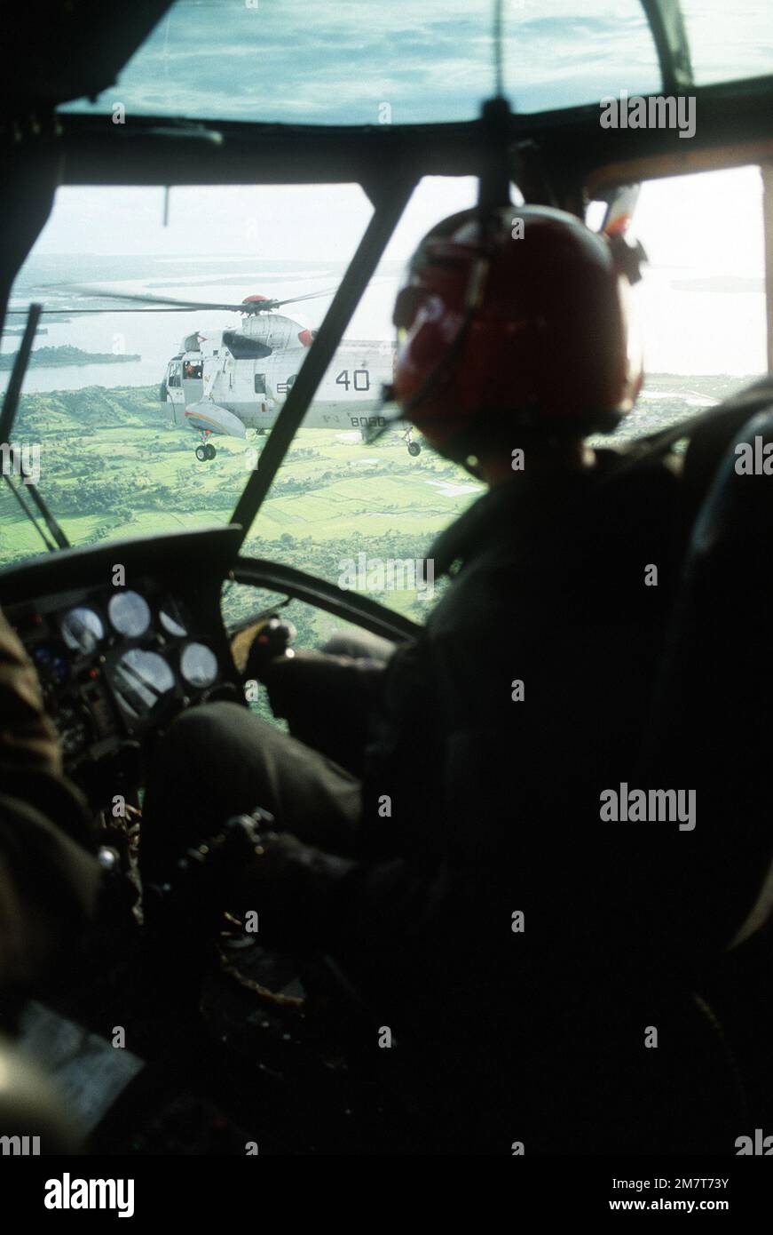 An air-to-air view of an SH-3 Sea King helicopter taken from the ...