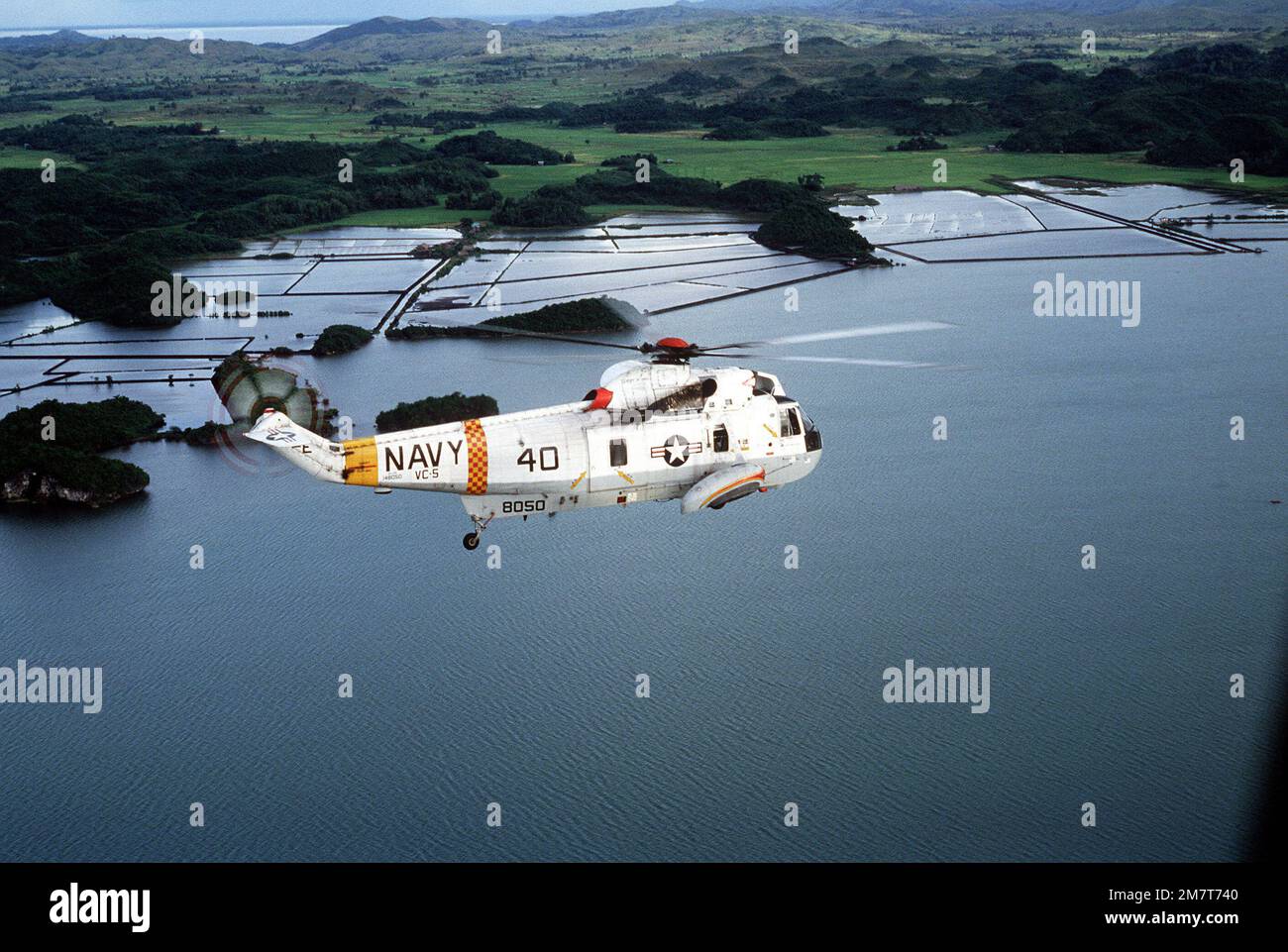 An air-to-air right side view of an SH-3 Sea King helicopter from Fleet ...