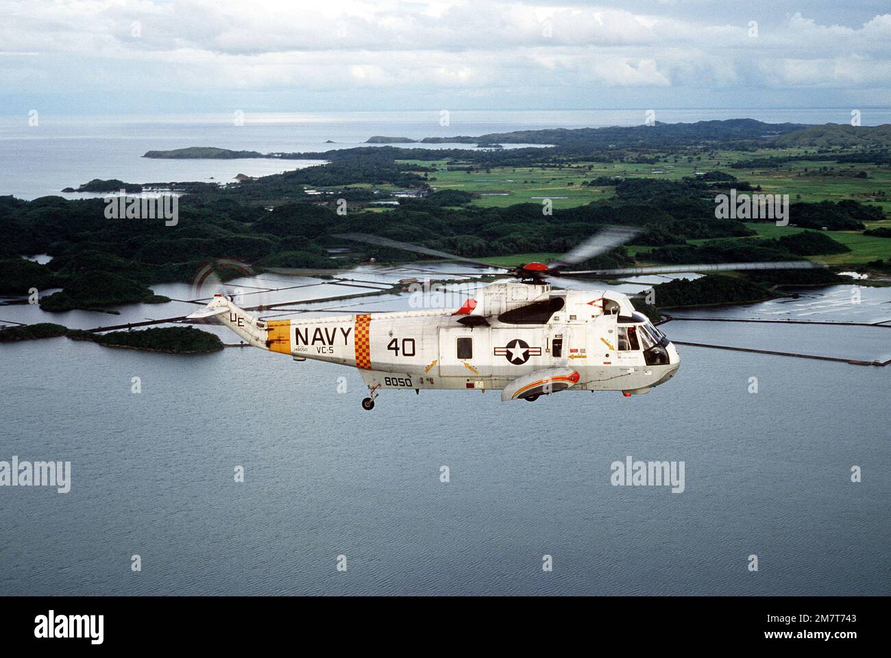 An air-to-air right side view of an SH-3 Sea King helicopter from Fleet ...