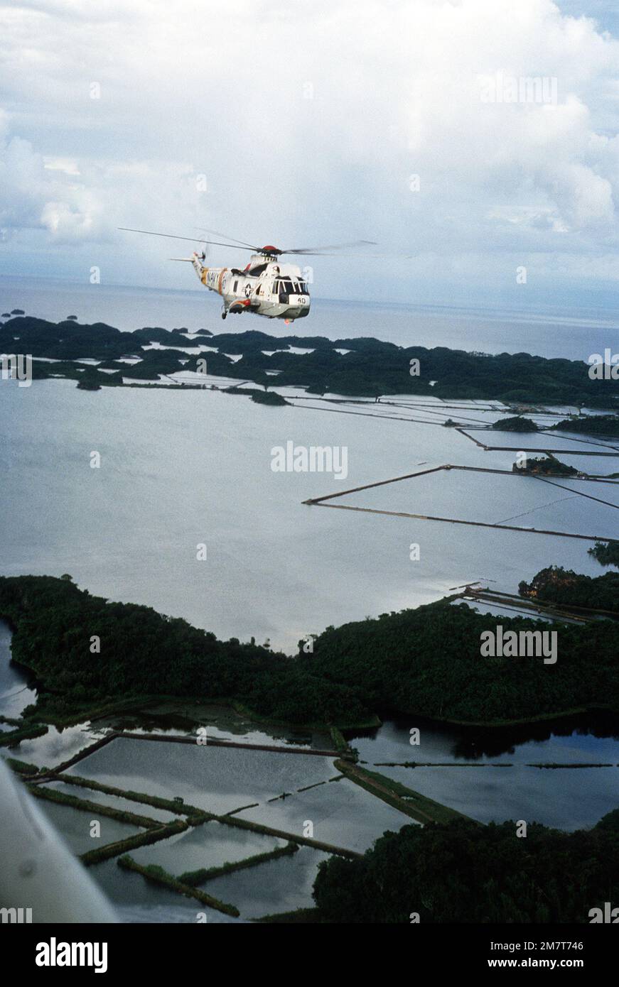 An air-to-air right front view of an SH-3 Sea King helicopter from ...