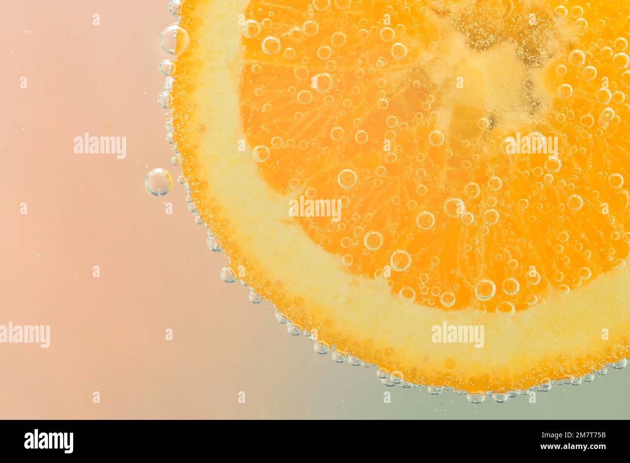 Orange fruit slice floating in club soda. Fresh orange slice with ...