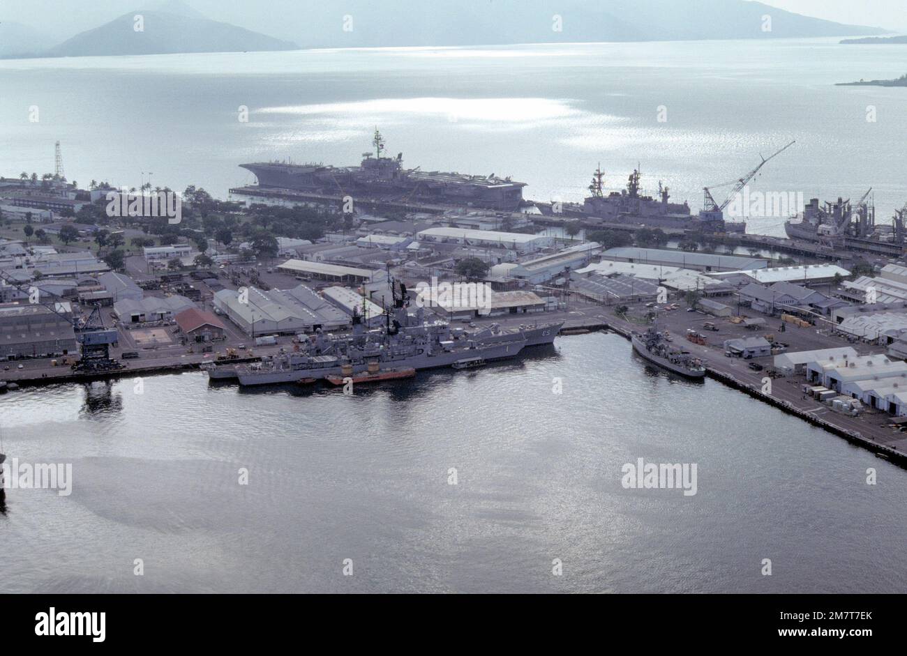 An aerial view of the aircraft carrier USS KITTY HAWK (CV-63) docked in ...