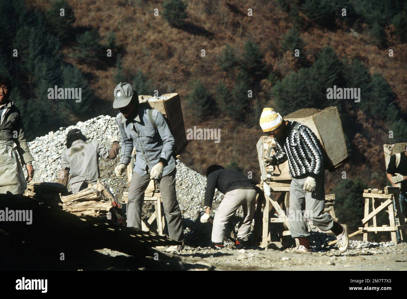 Koreans construct a concrete mock bridge in the target area at the ...