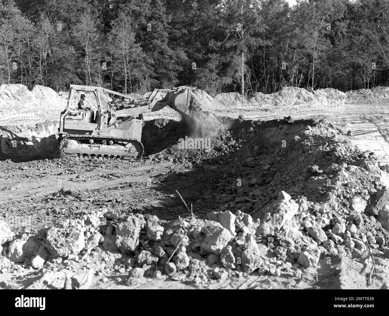 A tracked bulldozer operated by one of the maintenance crew is used to ...