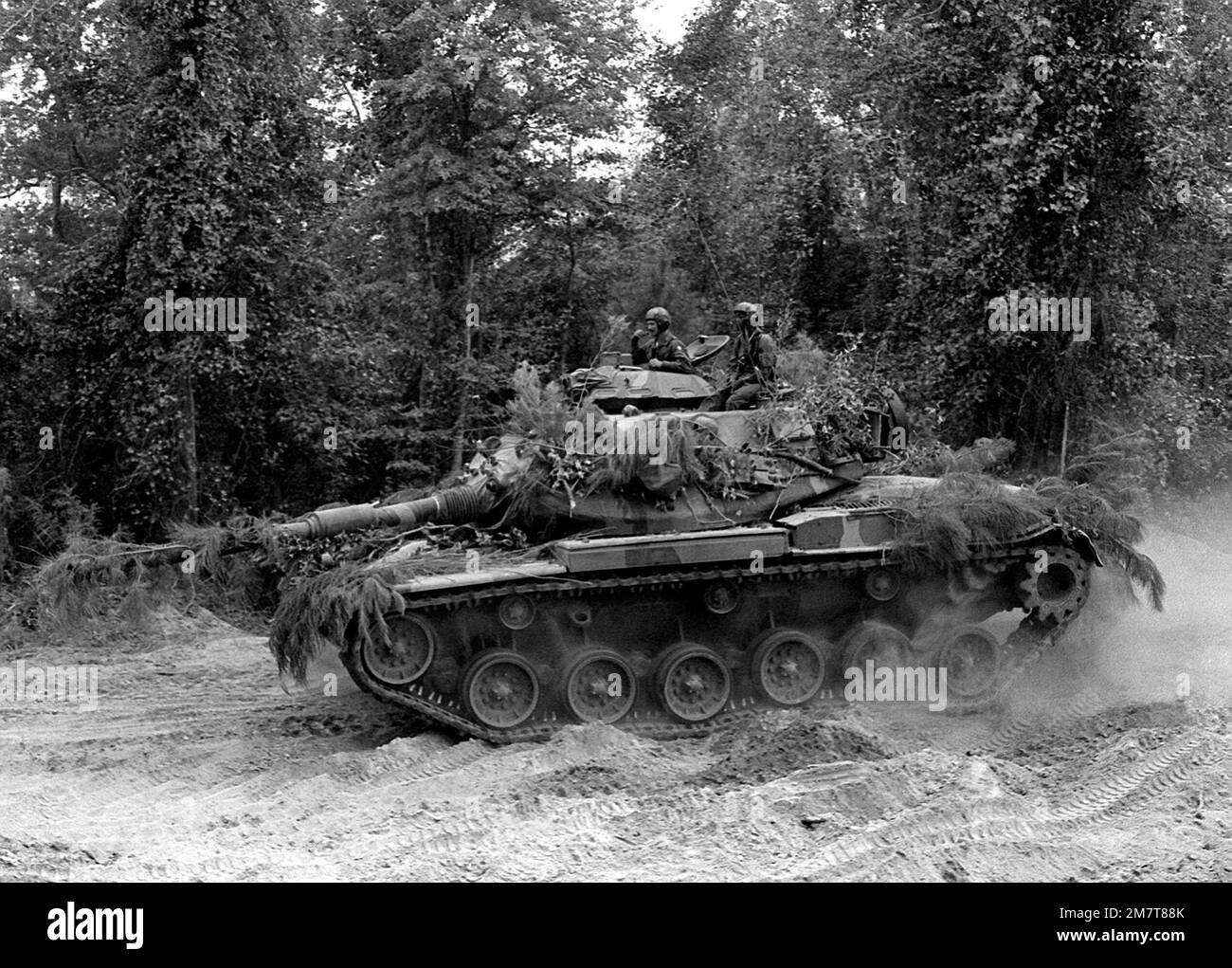 A camouflaged M-60A1 tank from the 8th Marines advances during an ...