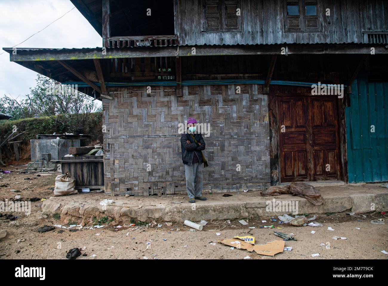 An old man standing in a village destroyed by heavy fire and airstrike ...