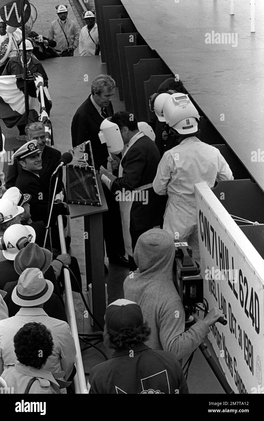 Secretary of Defense Caspar W. Weinberger wears a welding helmet and ...