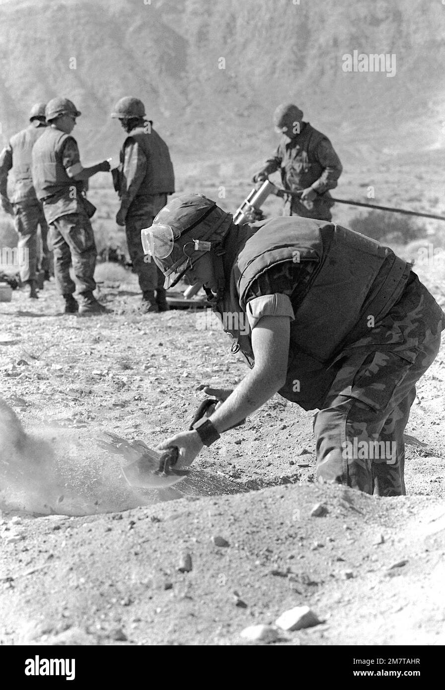 Prior to firing, CPL Williams checks the sight on this 105mm howitzer ...