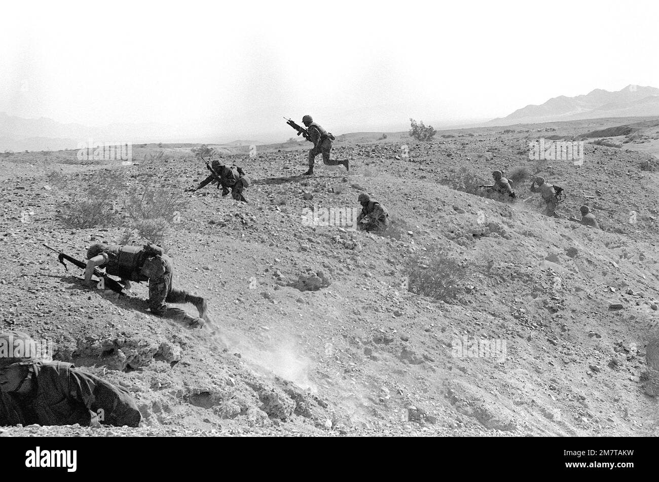 Some members of Co. L, 3rd Bn., 2nd Marines, move out and over a hill ...