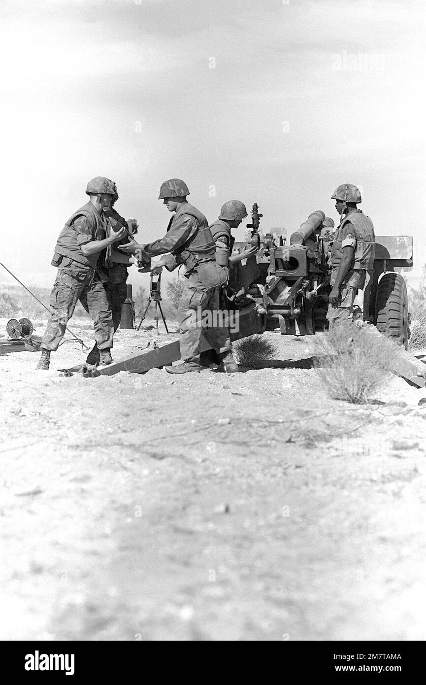 An artillery gun team from Btry. H, 1ST Bn., 10th Marines, prepares to ...