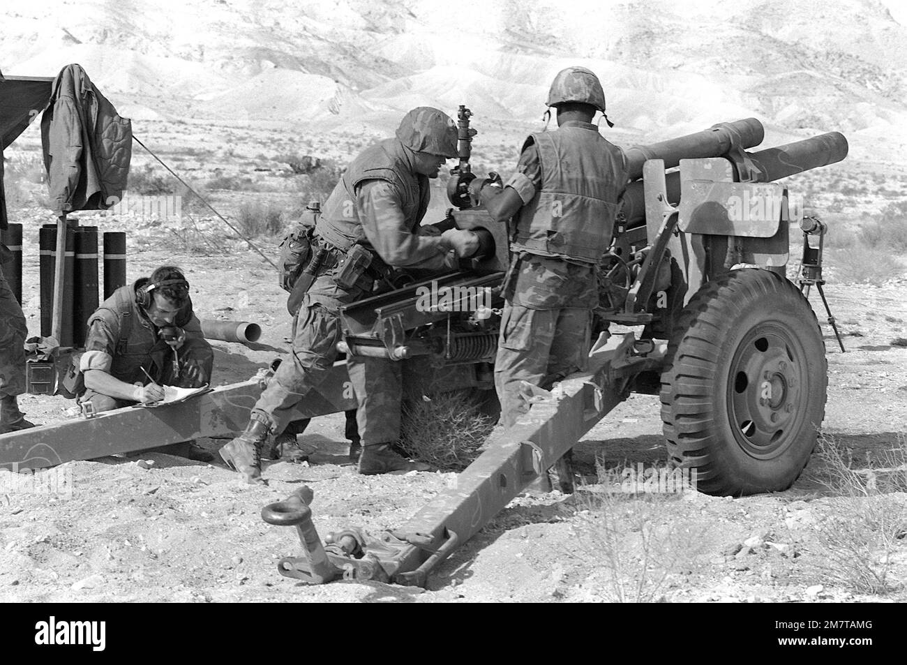 An artillery gun team from Btry. C, 5th Bn., 10th Marines, prepares to ...