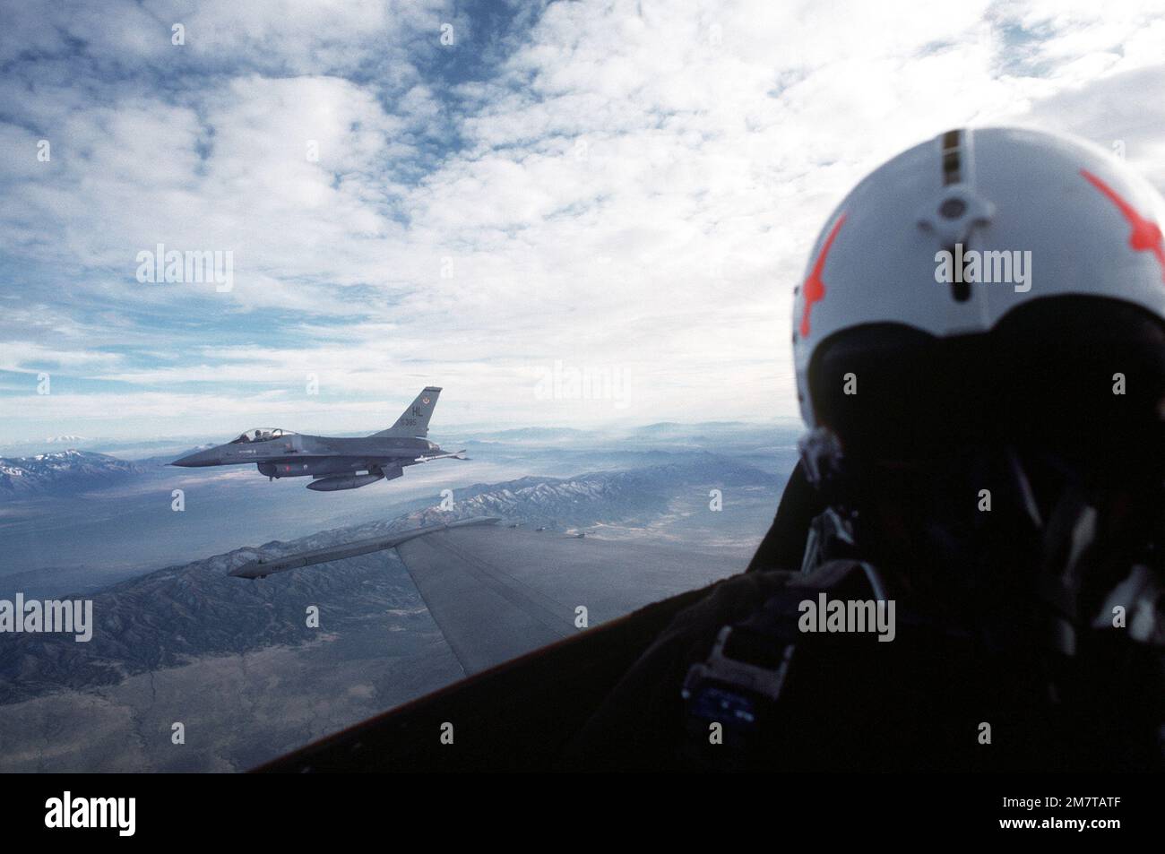 An air-to-air left side view of an F-16 Falcon aircraft assigned to the ...
