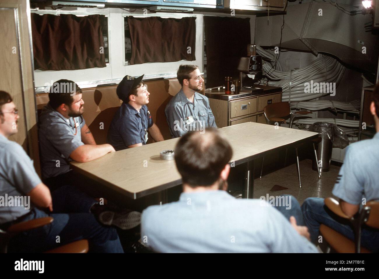 Six crewmen relax around a table in the crew lounge aboard the nuclear ...