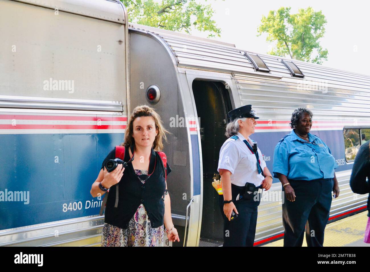 candid photo in front of cross-country train, ready to leave station in ...