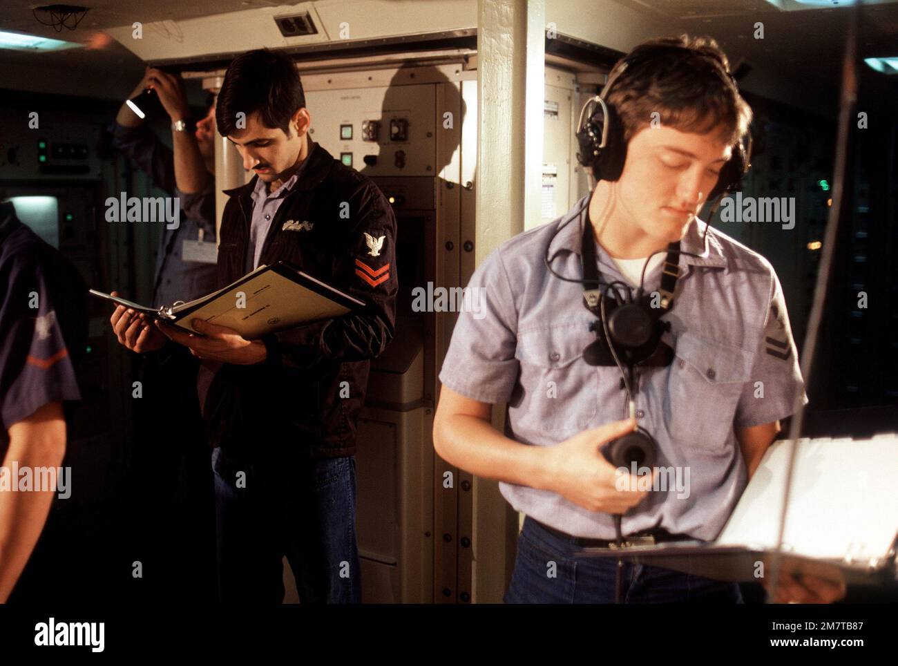 Crewmen participate in a simulated missile firing in the control room ...