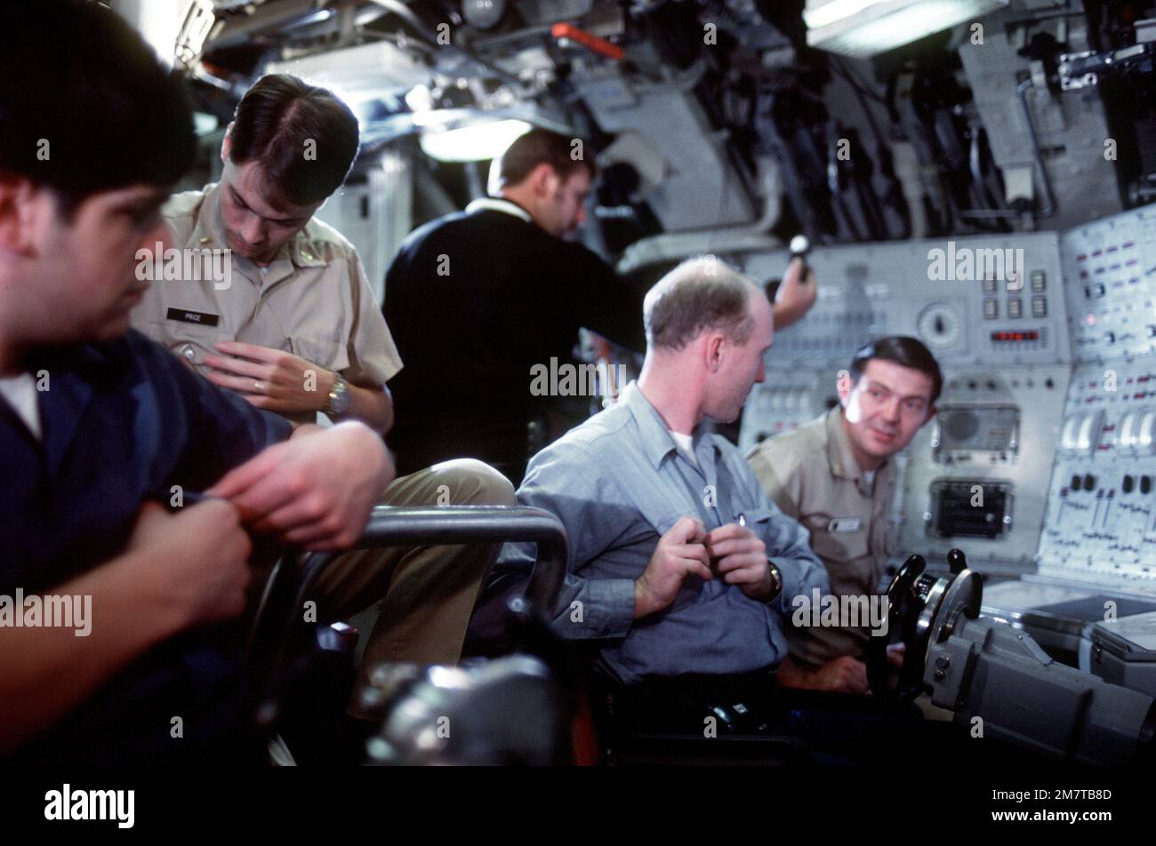 Crewmen in the control room prepare for a simulated diving operation ...