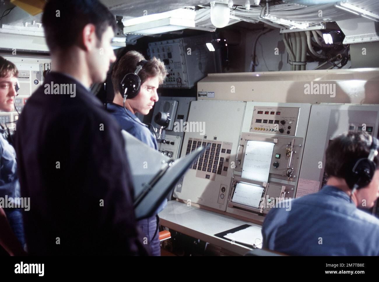 Four crew members participate in a simulated missile firing in the ...