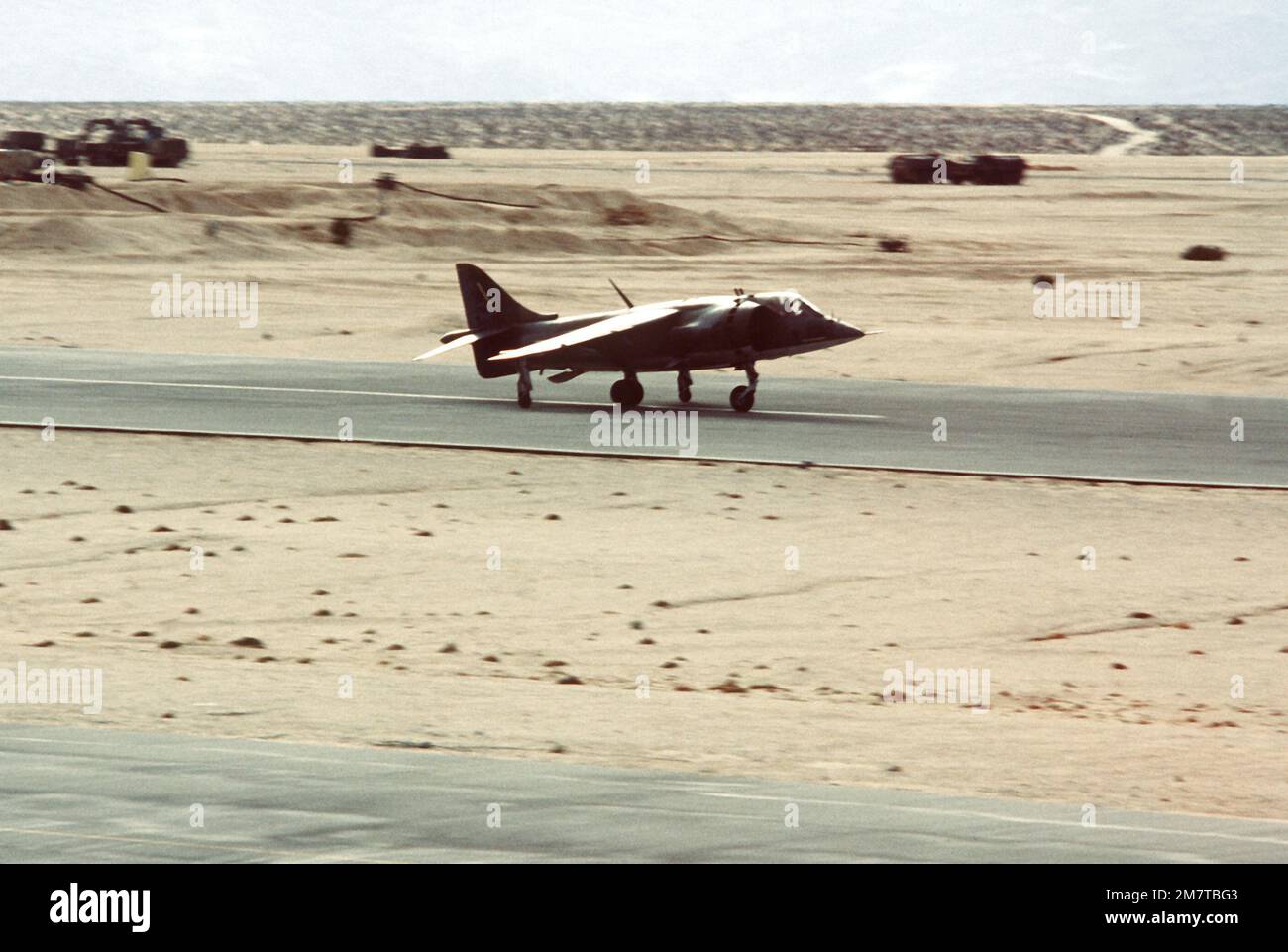 A Marine Corps AV-8A Harrier aircraft is on the runway waiting for ...