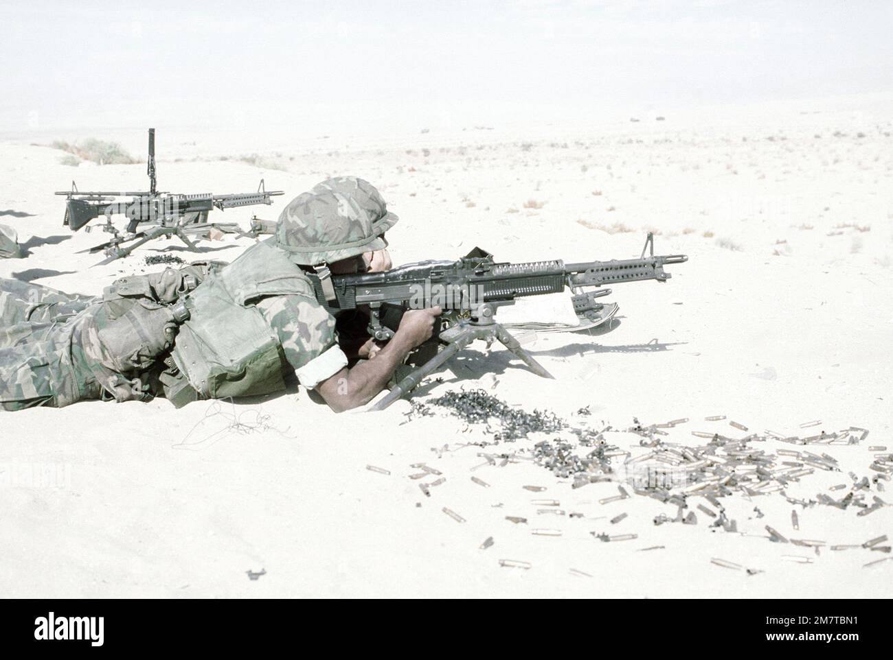 Two combat-ready Marines, an M-60A1 gunner and his assistant, are ...