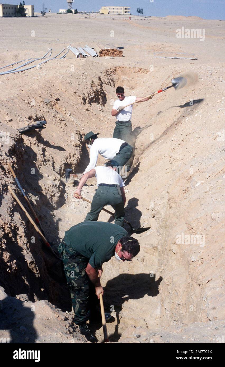 Military personnel dig a latrine trench during exercise Bright Star '82 ...