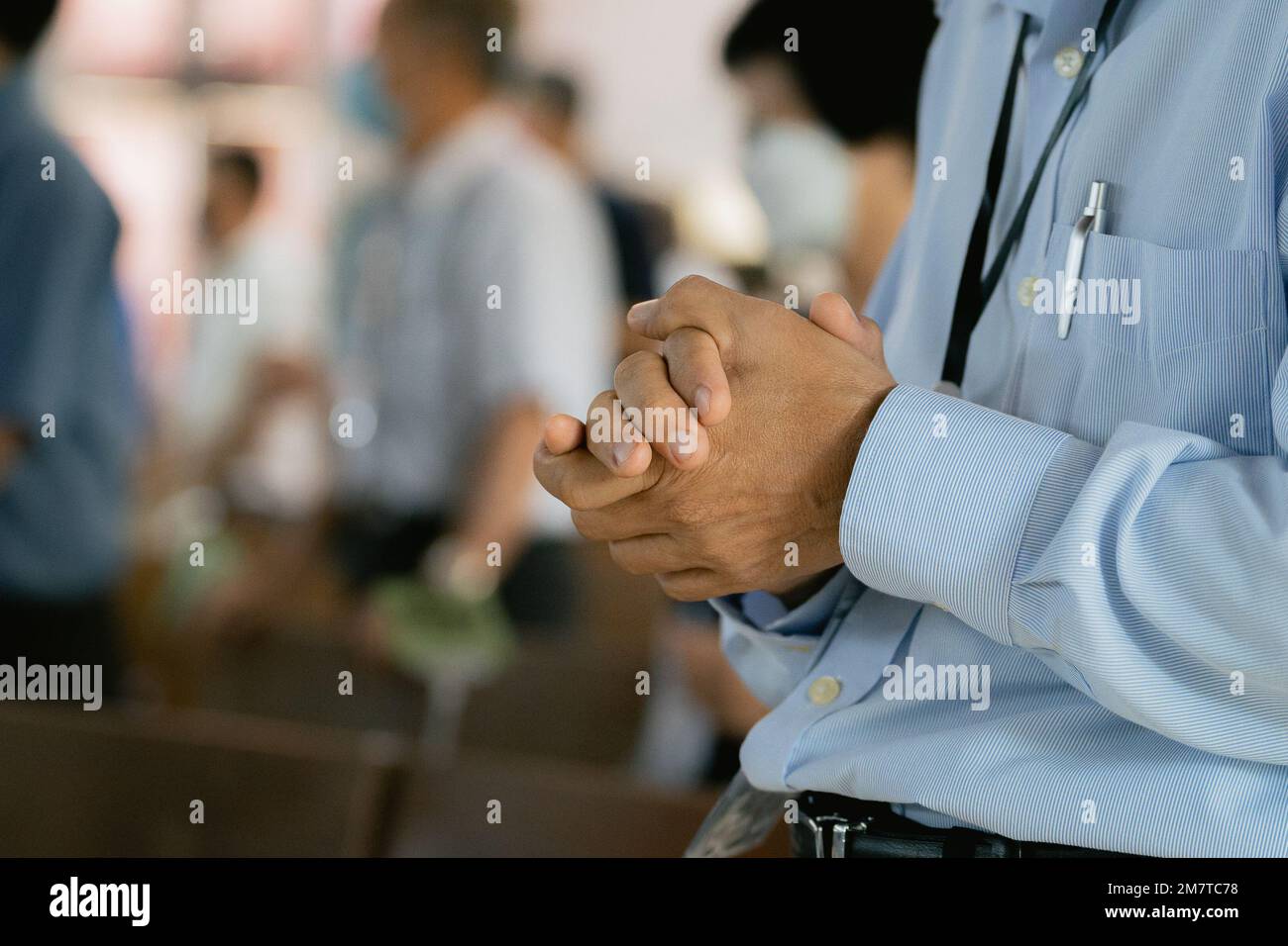 Closeup of smart religious Christian adult Asian man folded praying ...