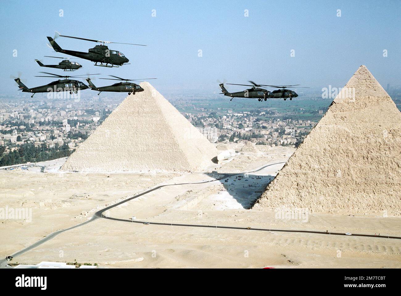 AN air-to-air right side view of UH-60 BlackHawk and AH-1G Cobra ...