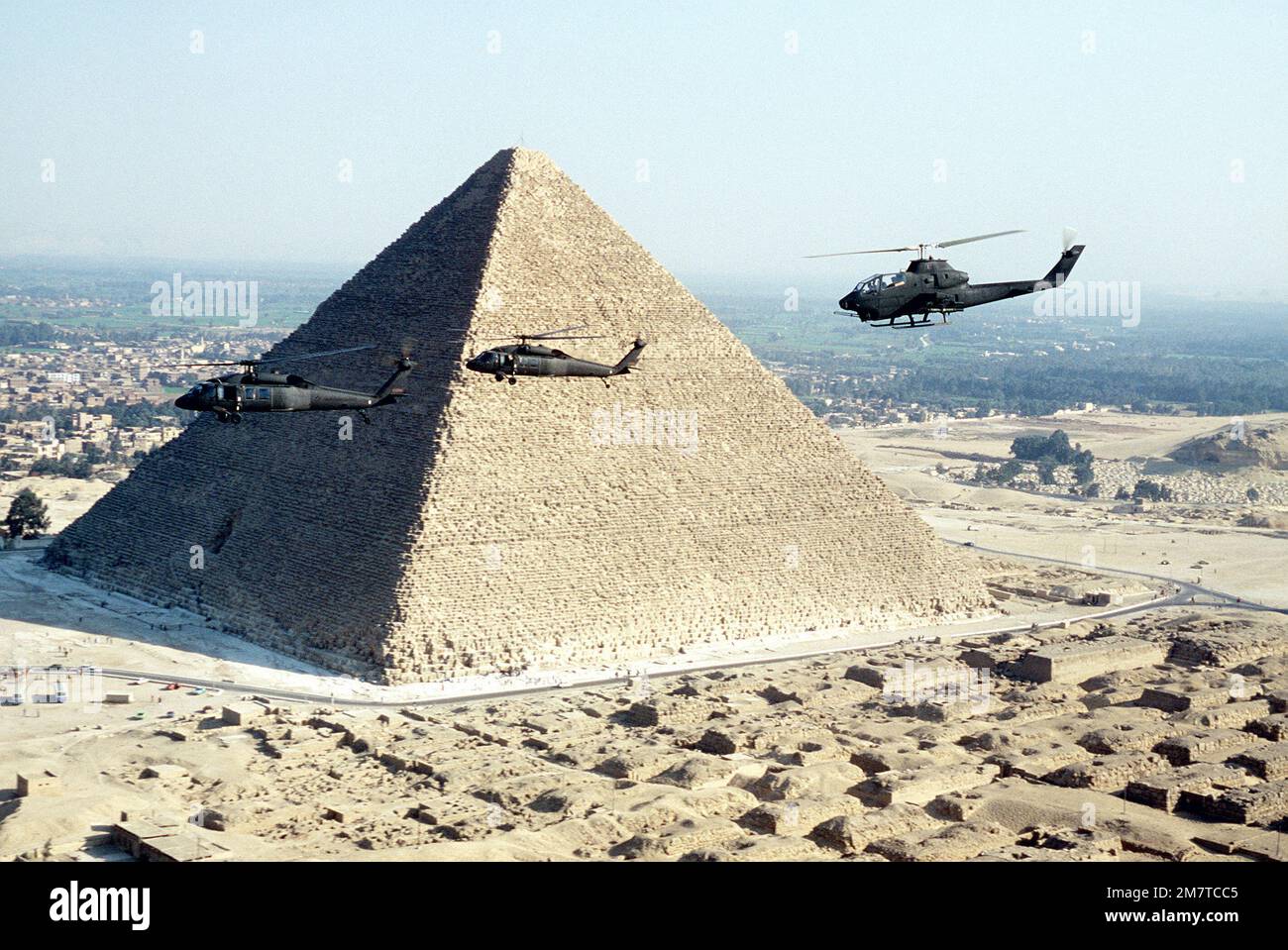 AN air-to-air left side view of two UH-60 BlackHawk and one AH-1G Cobra ...