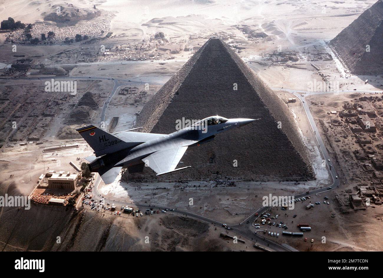 A right side view of an F-16 Fighting Falcon aircraft in flight in ...