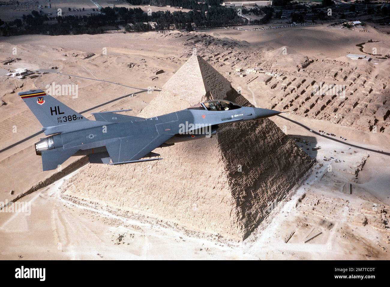 A right side view of an F-16 Fighting Falcon aircraft in flight in ...