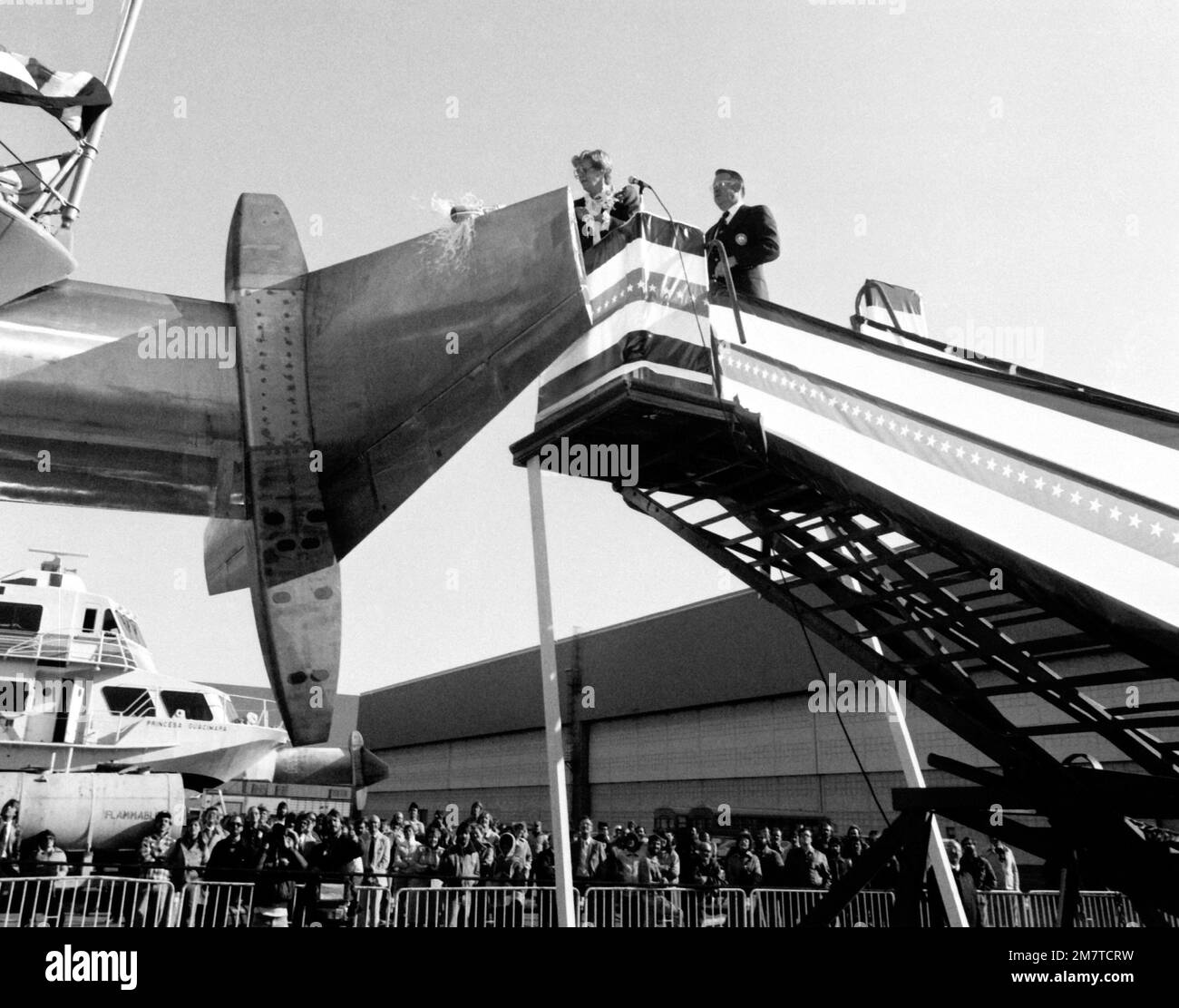 Mrs. Earl B. Fowler Jr., ship's sponsor, breaks the champagne bottle on ...