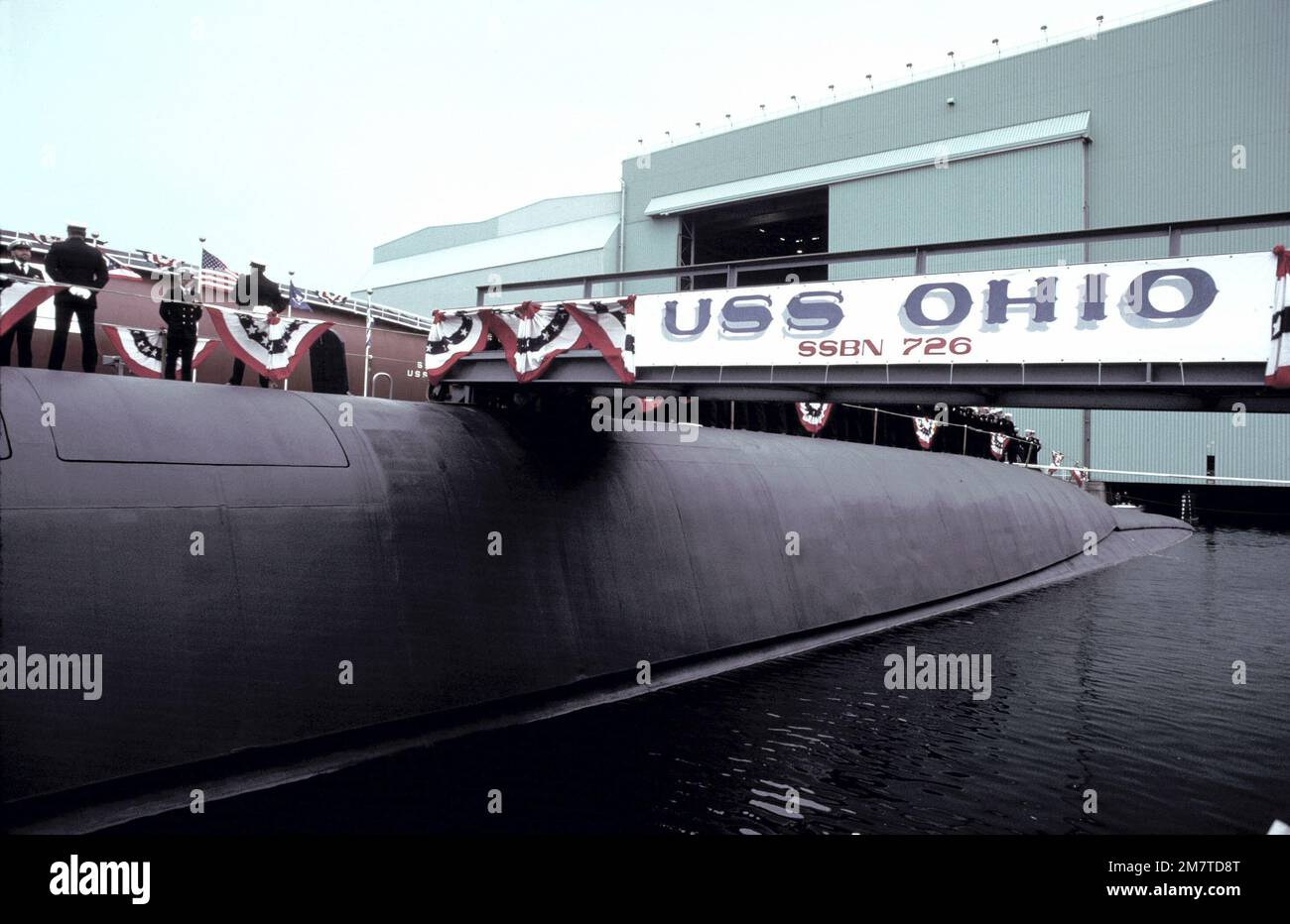 A view of the ramp as crew members man the rails of the nuclear-powered ...