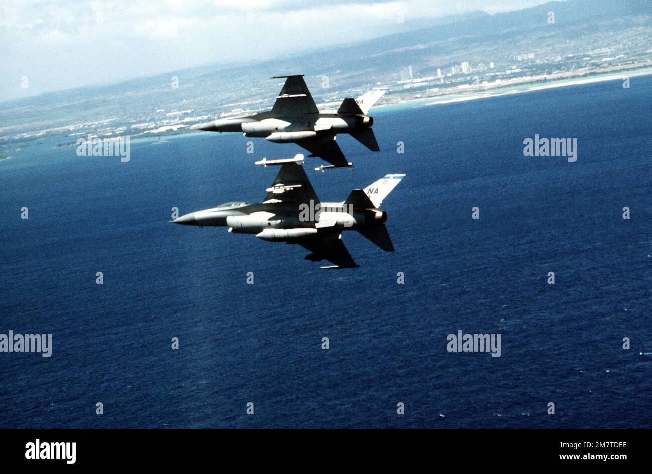 A left side view of two F-16 Fighting Falcon aircraft carrying AIM-9 ...