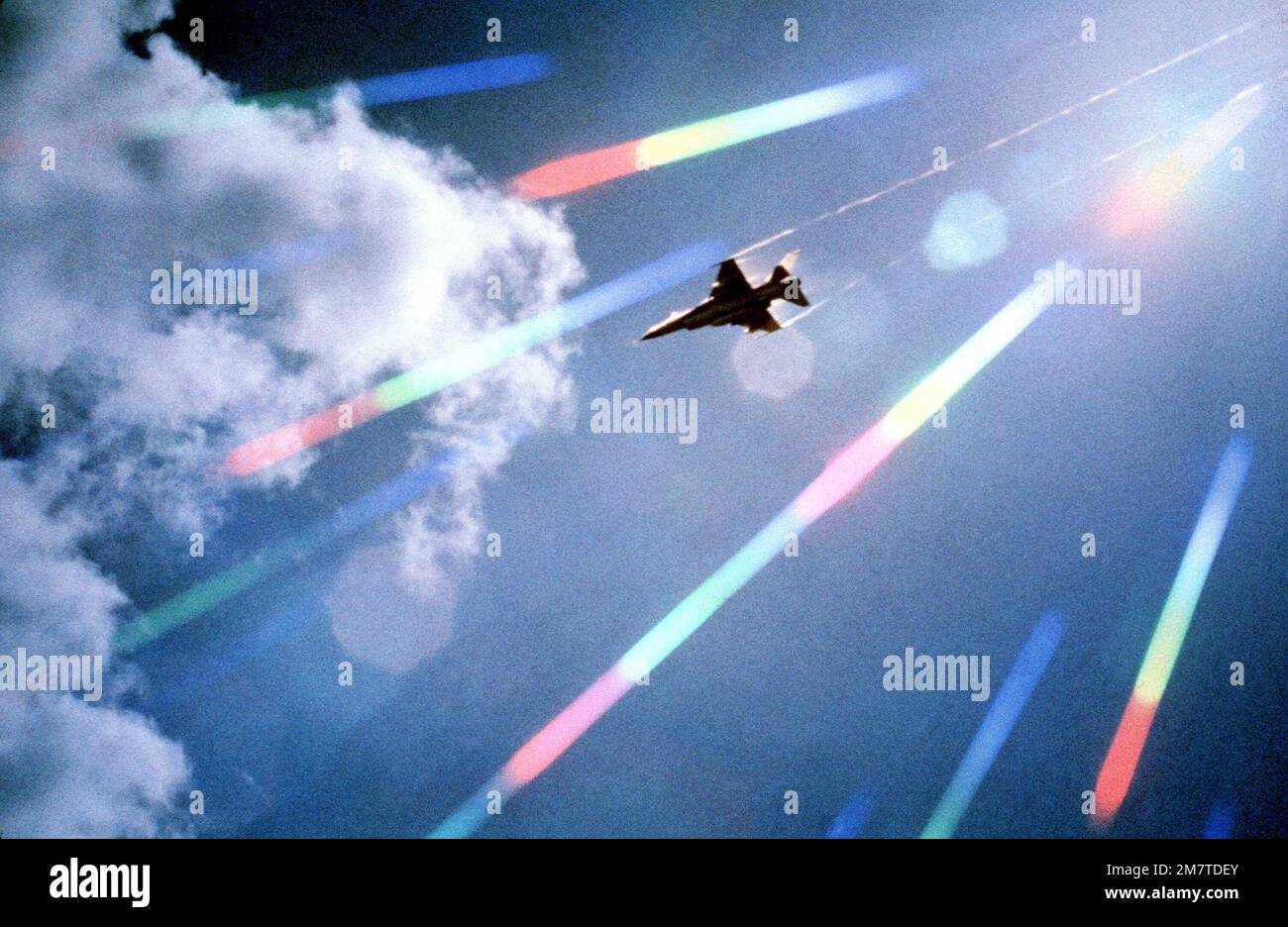 A bottom view of an F-16 Fighting Falcon aircraft carrying an AIM-9 ...