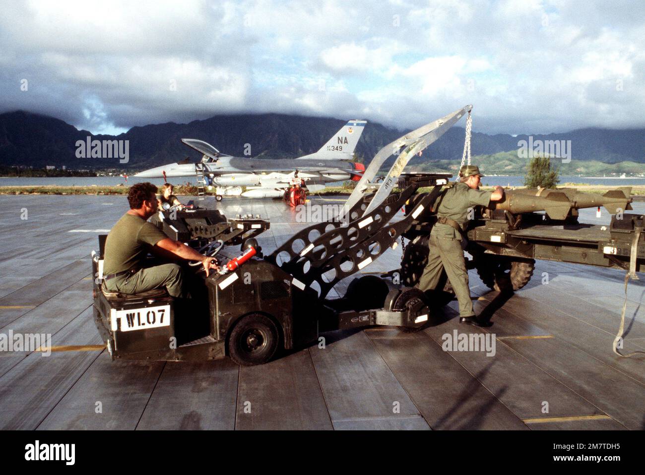 Airmen use a bomb loader to remove one of the Mark 82 500-pound laser ...