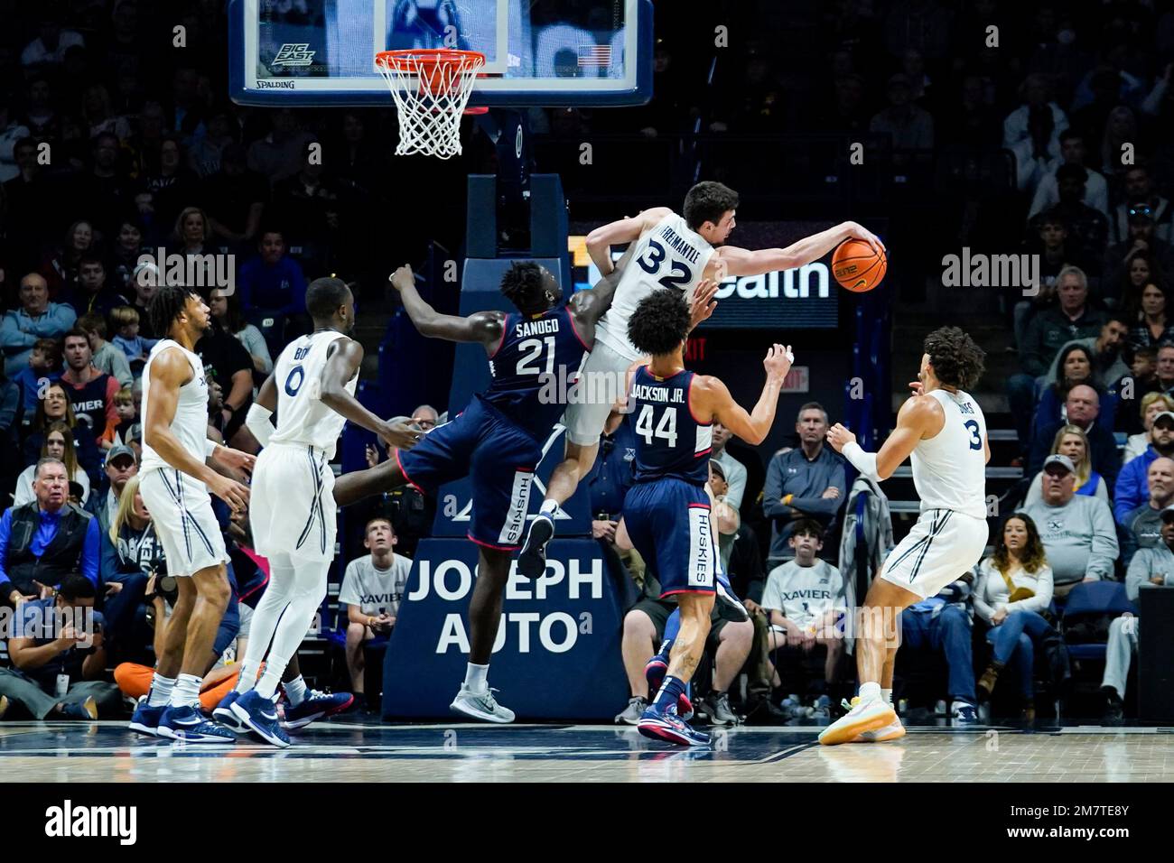 Xavier's Zach Freemantle (32) attempts to rebound against Connecticut's ...