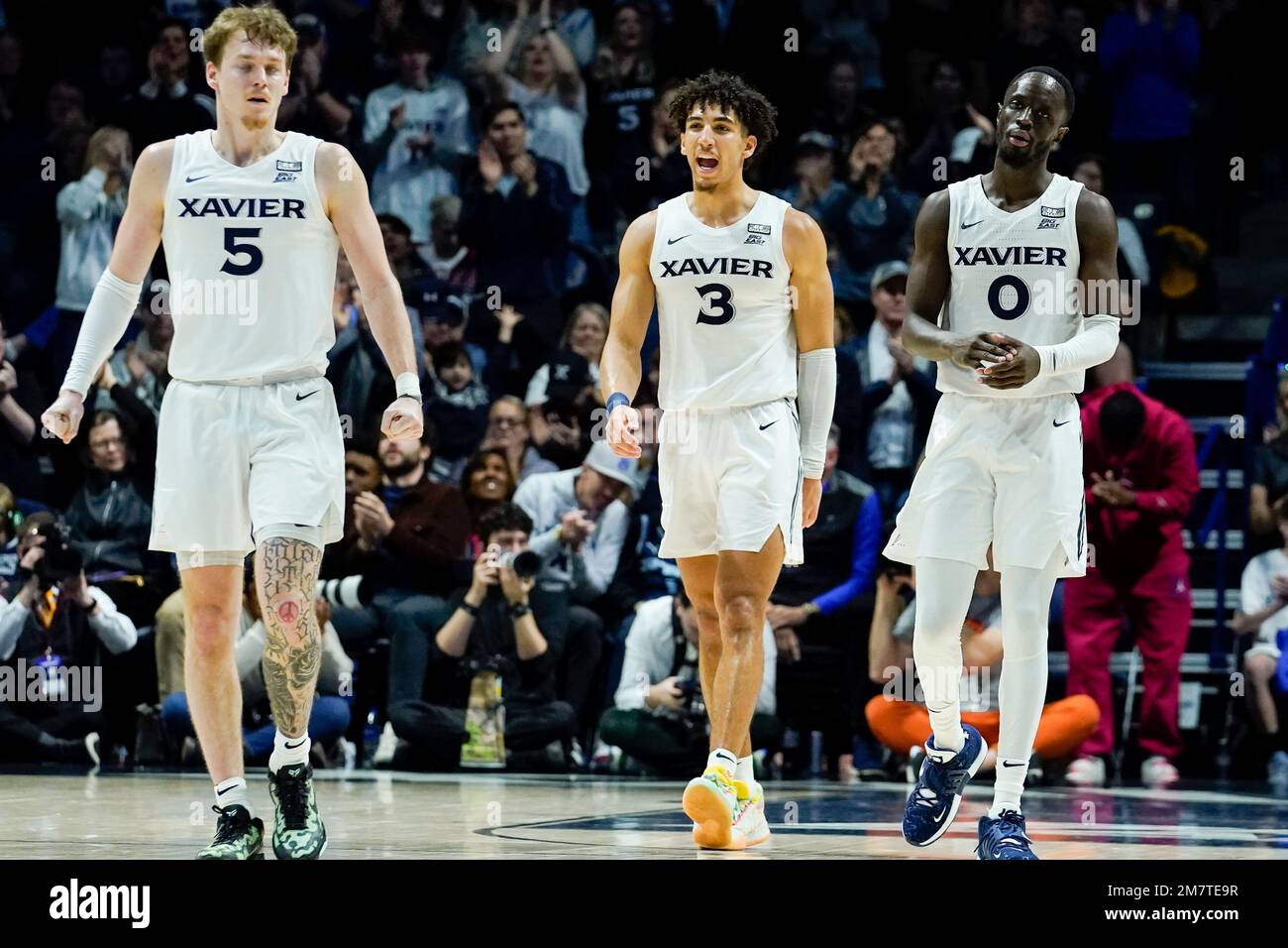Xavier's Adam Kunkel (5), Colby Jones (3) and Souley Boum (0) play ...